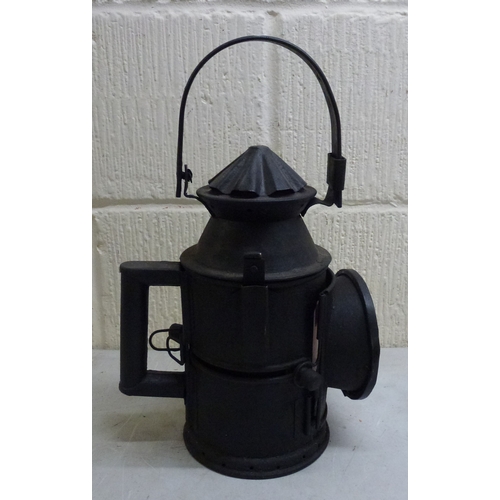 A reproduction of a vintage black painted iron railway signal lamp 12"h