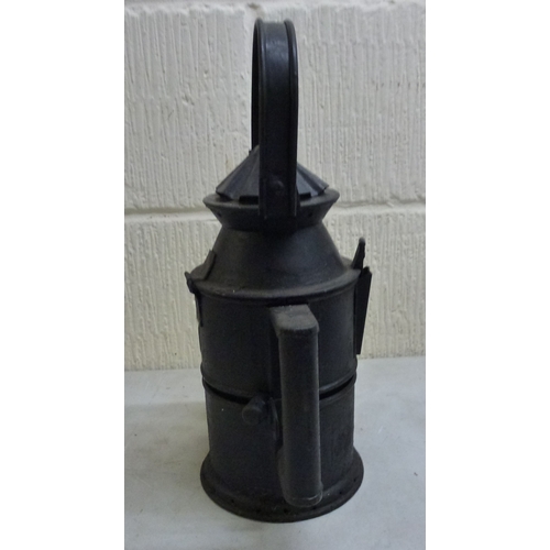 A reproduction of a vintage black painted iron railway signal lamp 12"h