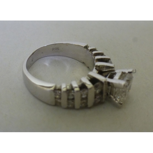 A white metal single stone ring, set with diamonds stamped 14k (approx ...