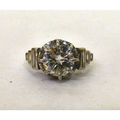 A platinum diamond claw set solitaire ring with emerald cut graduated ...