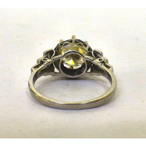 A platinum diamond claw set solitaire ring with emerald cut graduated ...