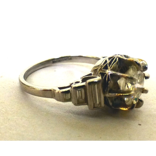 A platinum diamond claw set solitaire ring with emerald cut graduated ...