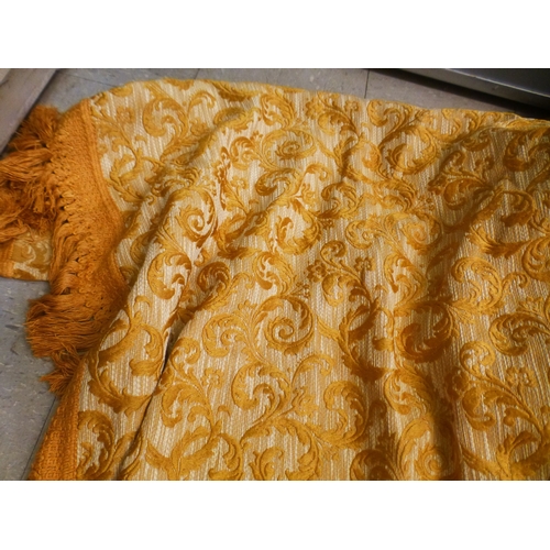 Two dissimilar patterned old gold coloured fabric throws