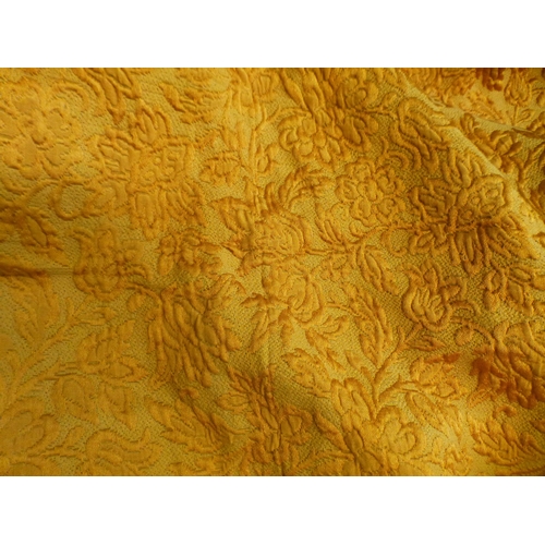 Two dissimilar patterned old gold coloured fabric throws