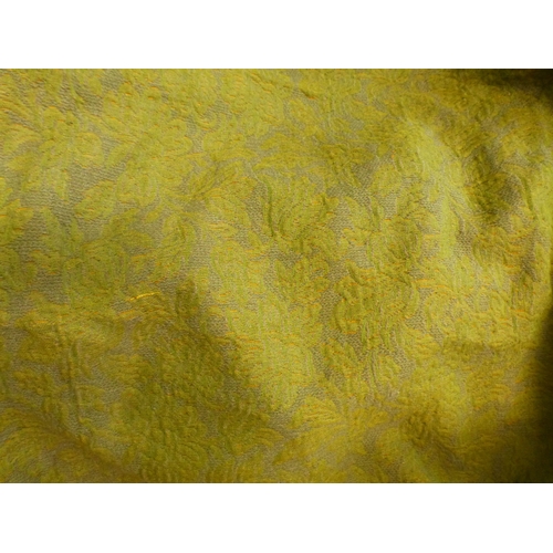 Two dissimilar patterned old gold coloured fabric throws
