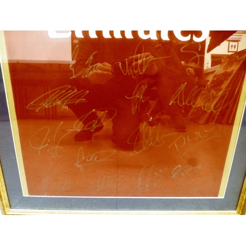 An Arsenal FC strip bearing signatures from the squad with a ...