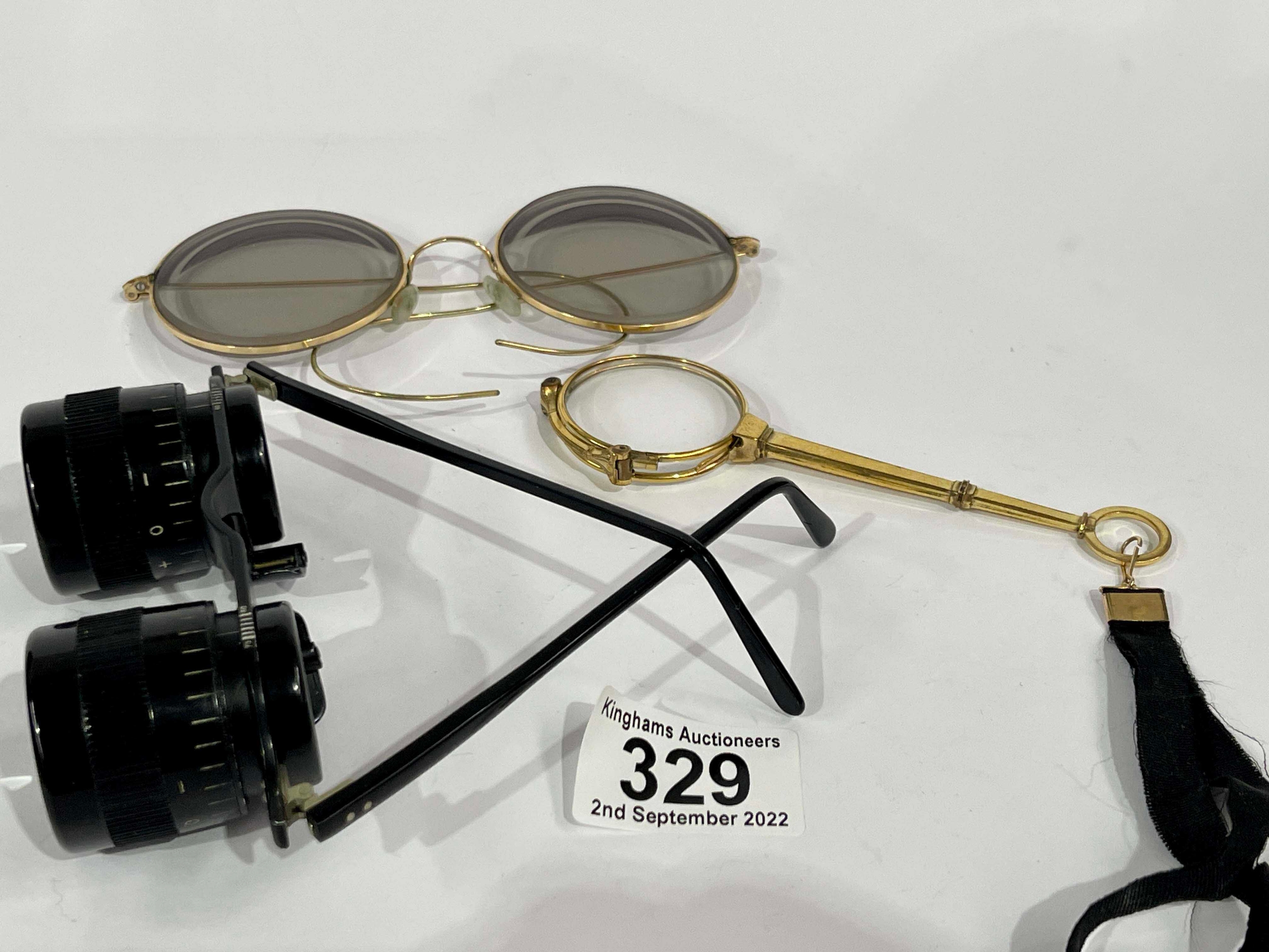 A pair of gold plated tinted lens glasses by Algha of Saville Row, a ...