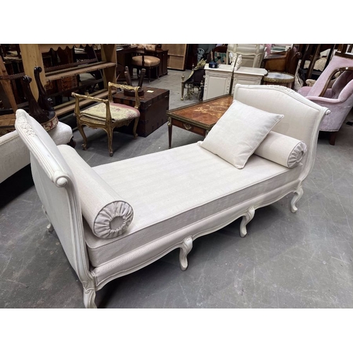 A French style daybed, the white painted frame with moulded floral ...