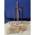 A collection of Victorian cane carpet beaters, walking sticks etc