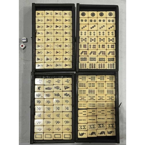 A wooden cased bone and bamboo mahjong set, the case inlaid with mother ...
