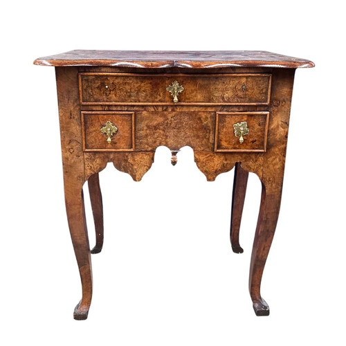 A George 1 walnut lowboy, on slight cabriole legs down to square pad ...