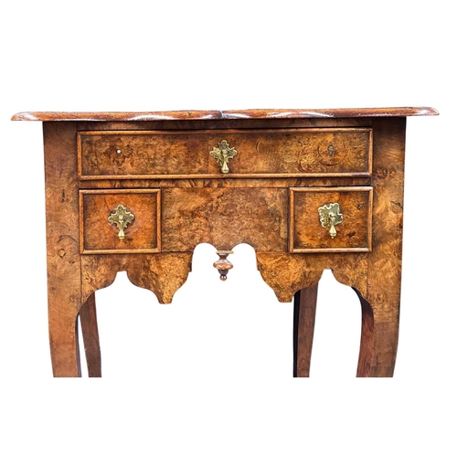 A George 1 walnut lowboy, on slight cabriole legs down to square pad ...