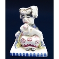 A Peggie Foy pottery figure of the Duchess, the Pig Baby and the ...