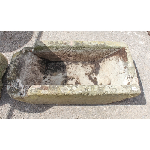 A well weathered rectangular composite stone garden trough or sink