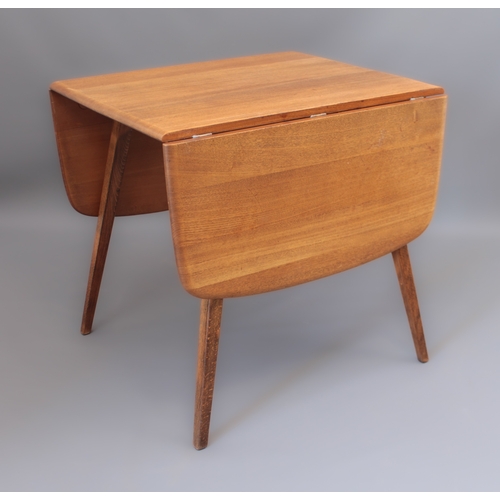 A 1970s beech and elm drop-flap dining table, probably Ercol - the ...