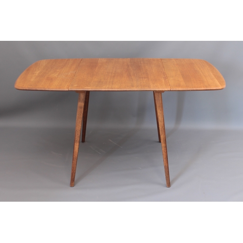 A 1970s beech and elm drop-flap dining table, probably Ercol - the ...