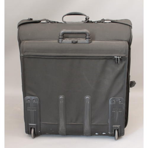 A large TUMI vinyl flight bag - wheeled and with retractable handle ...