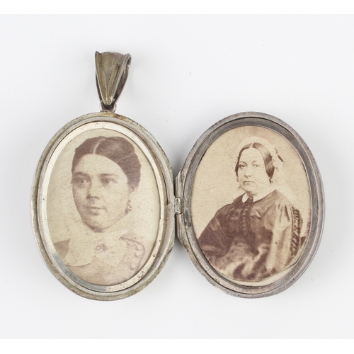 A Victorian silver locket - Thomas Lyster Mott, Chester 1878, oval with ...