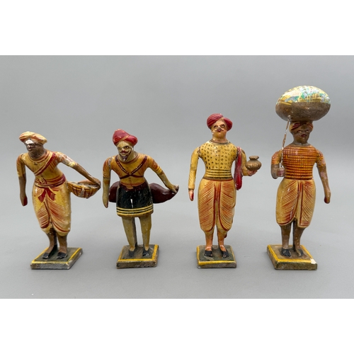 A group of ten carved wooden and hand painted Indian figures - mostly ...