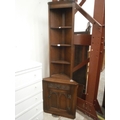 A vintage carved oak corner unit with drawer