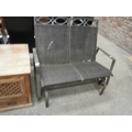 A metal framed 2 seater rocking patio seat