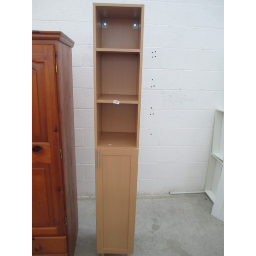 A modern slim storage tower with open shelves and lower cupboard