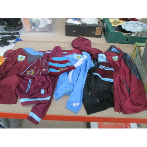 A quantity of assorted Burnley FC tops, jackets and hats
