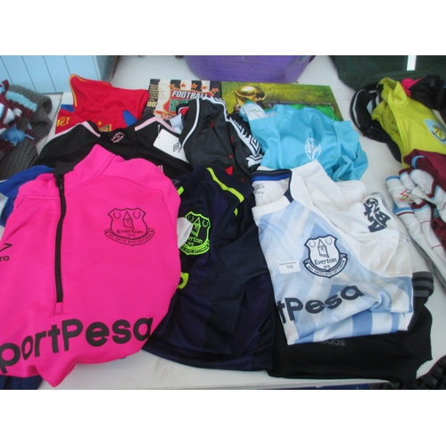 Quantity of assorted football shirts mostly Everton with two football books