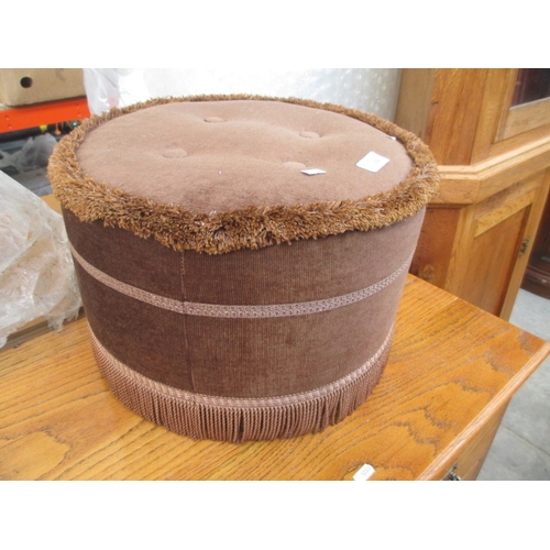 A vintage upholstered pouffe