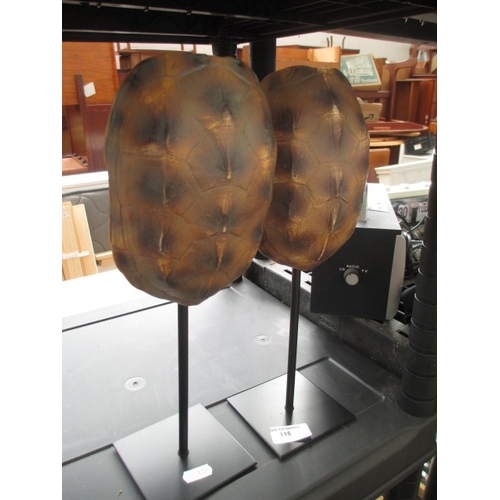Two tortoise shells on metal stands