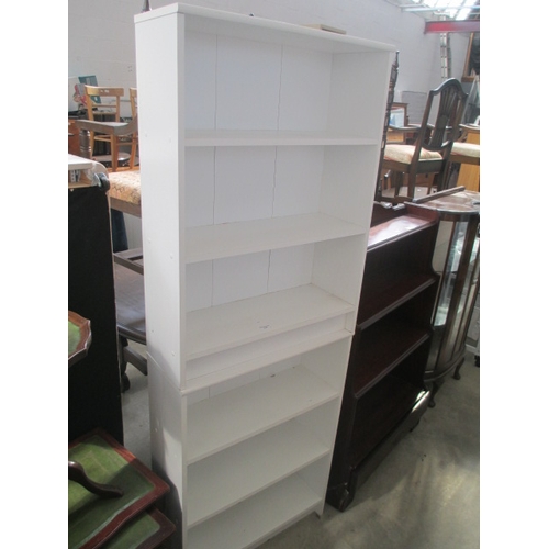 A pair of small white open shelf stands