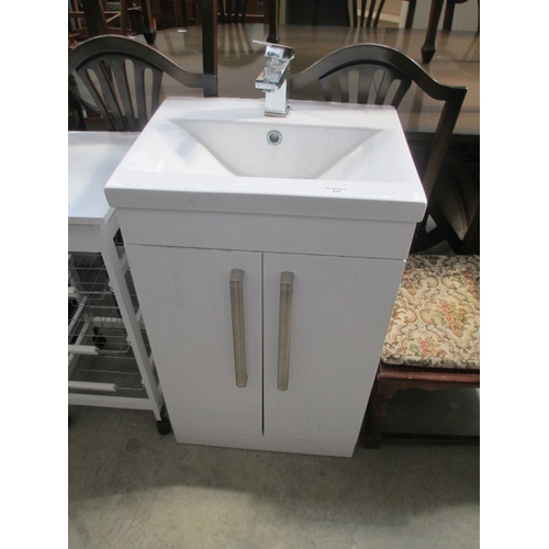 A small wash basin unit in 2 door cabinet