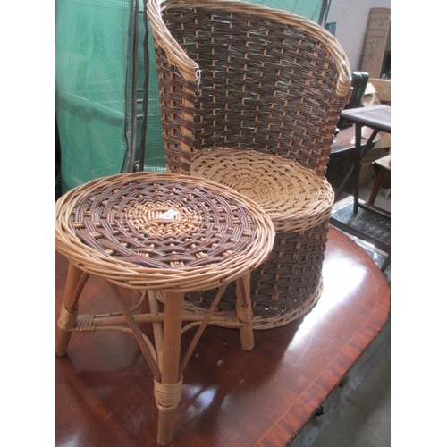 A small wicker basket chair and matching table