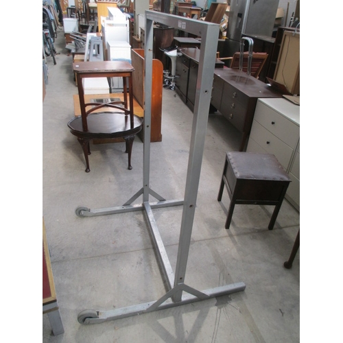A square section metal frame with casters