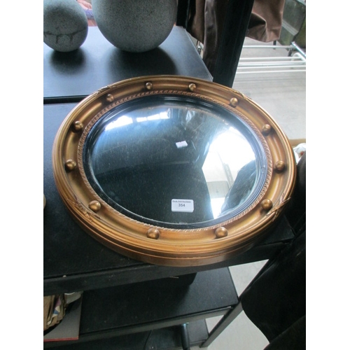 Ornate gilt edged porthole mirror