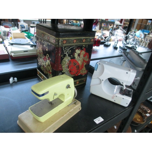 Two mini sewing machines and oriental patterned tin box
