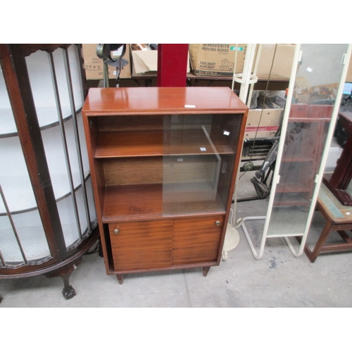 A small vintage cabinet with glass sliding doors