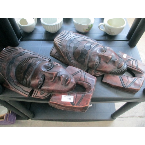 Two carved wooden mask plaques