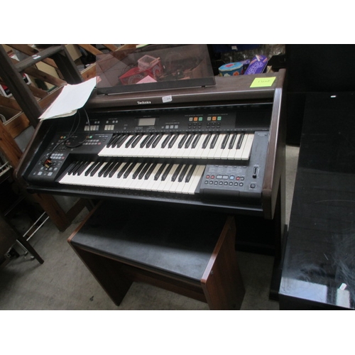A large TECHNICS PCM Sound electronic organ with stool