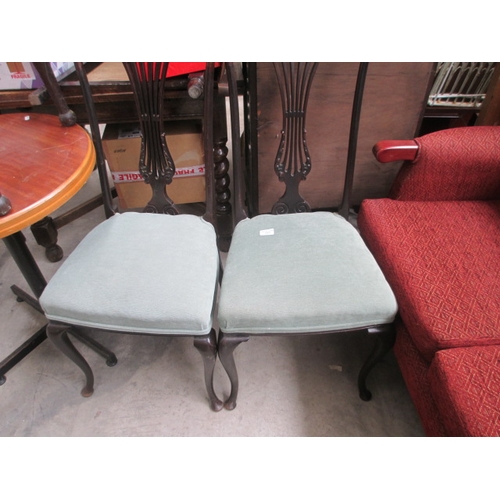 A pair of carved antique mahogany stand chairs