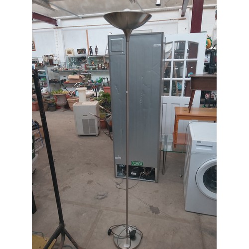 A modern stainless steel uplighter