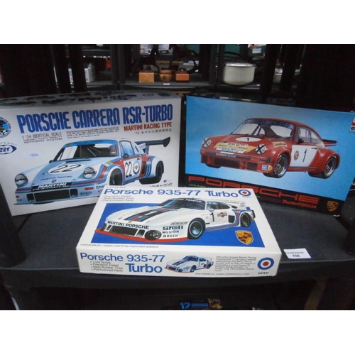 Three assorted car model kits