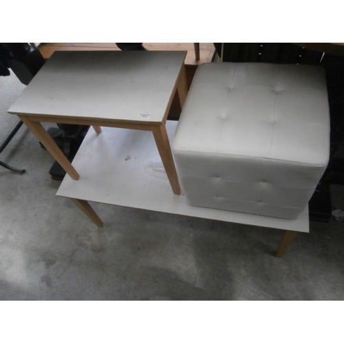 A buttoned white vinyl pouffe and 2 x small tables