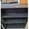 An open black shelf unit
