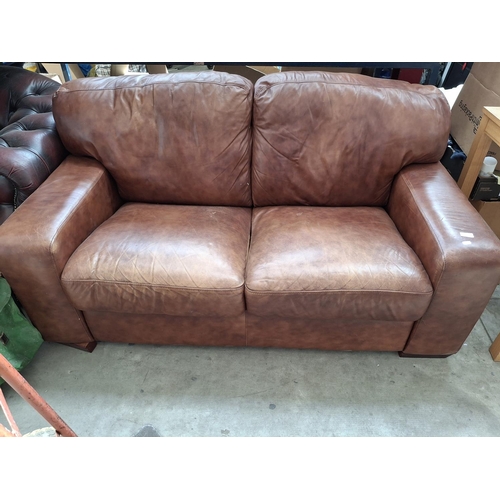 A padded brown leather settee