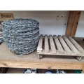 Reel of barbed wire and plant pot trolley