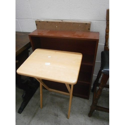 A small folding table, an open shelf stand and a folding pasting table