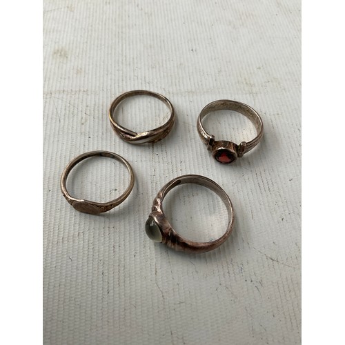 Four silver stamped rings