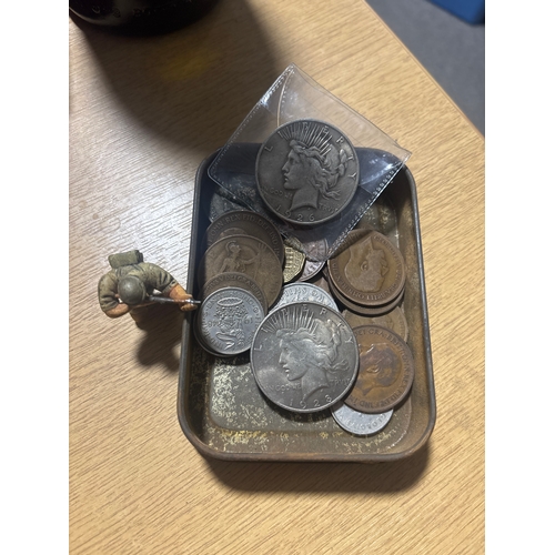 Tin of coins including figure