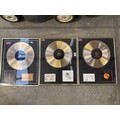 Three framed gold discs